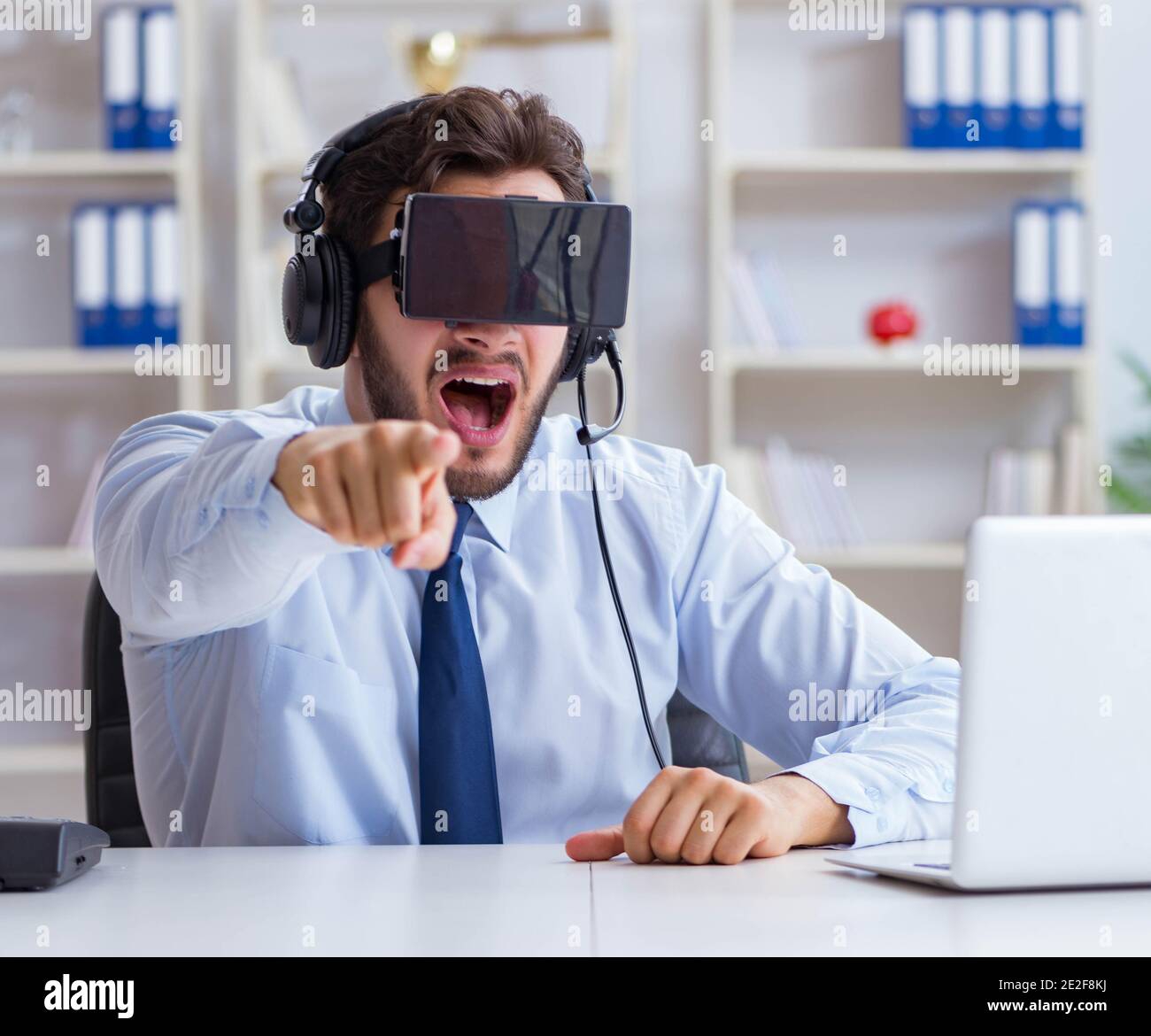 The businessman gamer in office playing games Stock Photo - Alamy