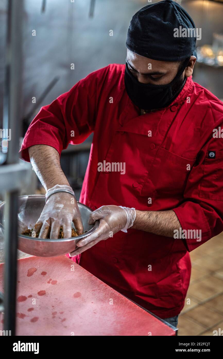 Chef preparing cooking and serving indian cuisine style dish Stock ...