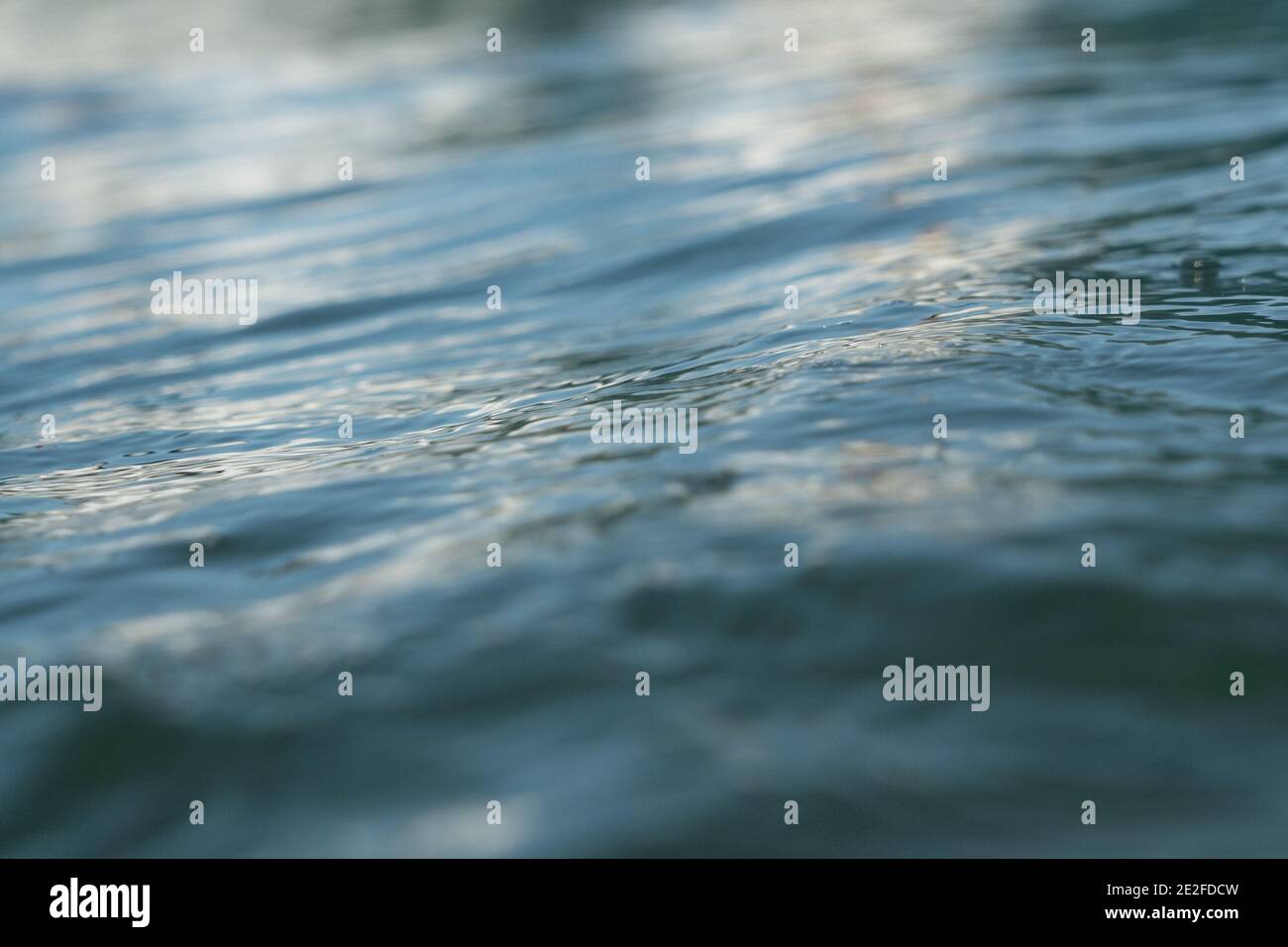 Close up shallow focus of sea, ocean, water, ripples with reflection ...