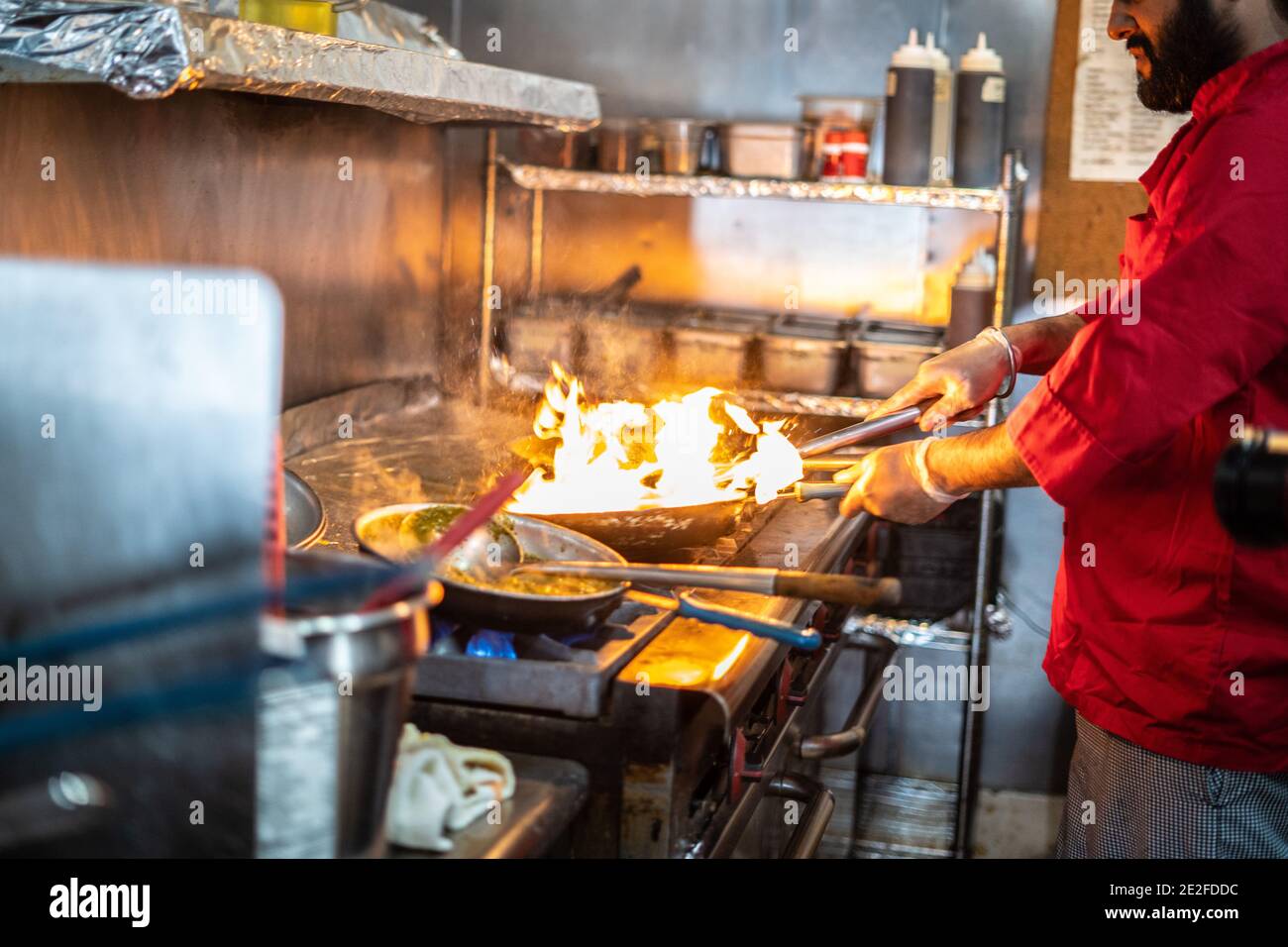 Chef preparing cooking and serving indian cuisine style dish Stock ...