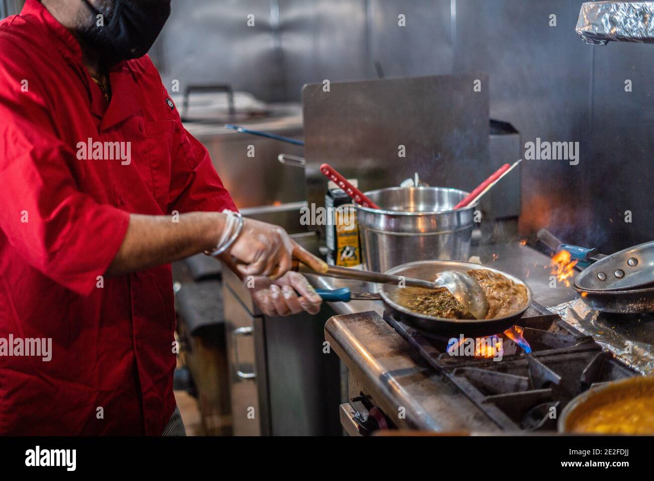 Chef preparing cooking and serving indian cuisine style dish Stock ...