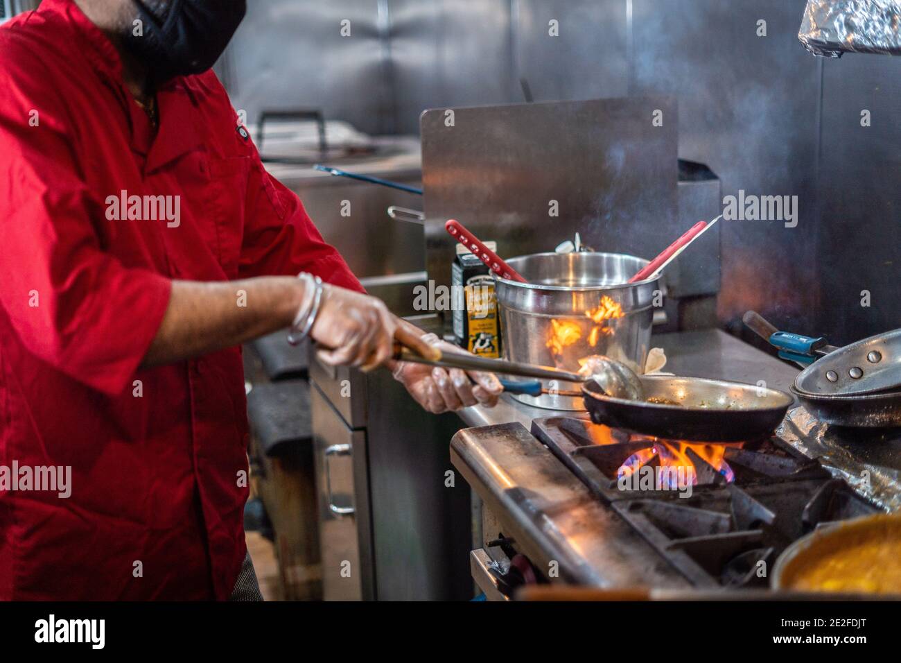 Chef preparing cooking and serving indian cuisine style dish Stock ...
