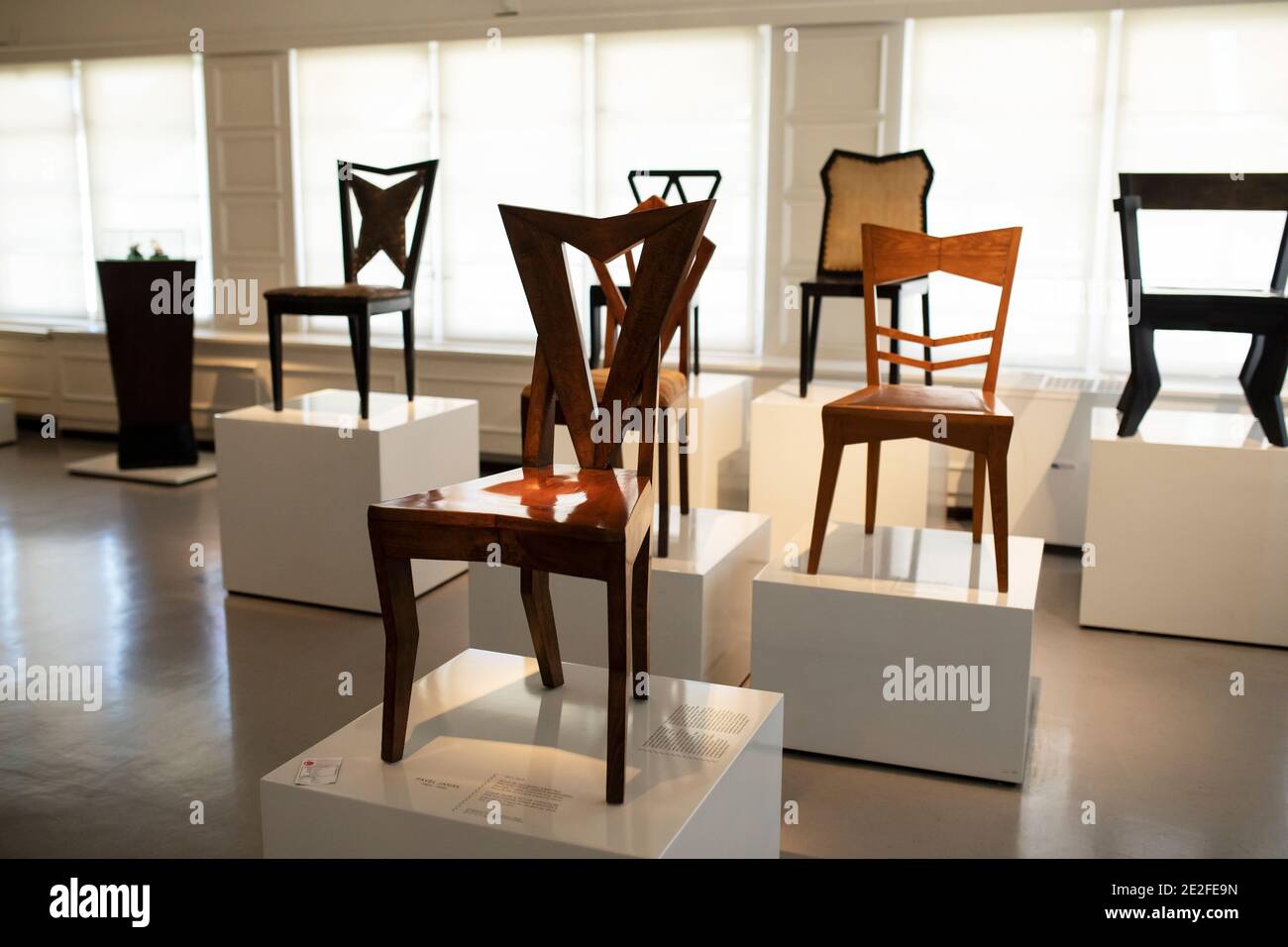 A collection of chairs on display at the Cubist Museum in Prague ...