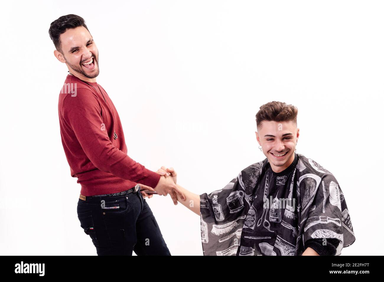 Smiling barber and his client on white background Stock Photo - Alamy