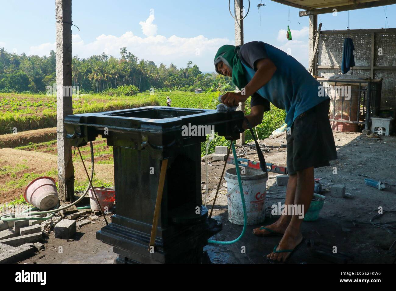 Asian man is washing the stone slabs in factory. cutted stone slabs on ...