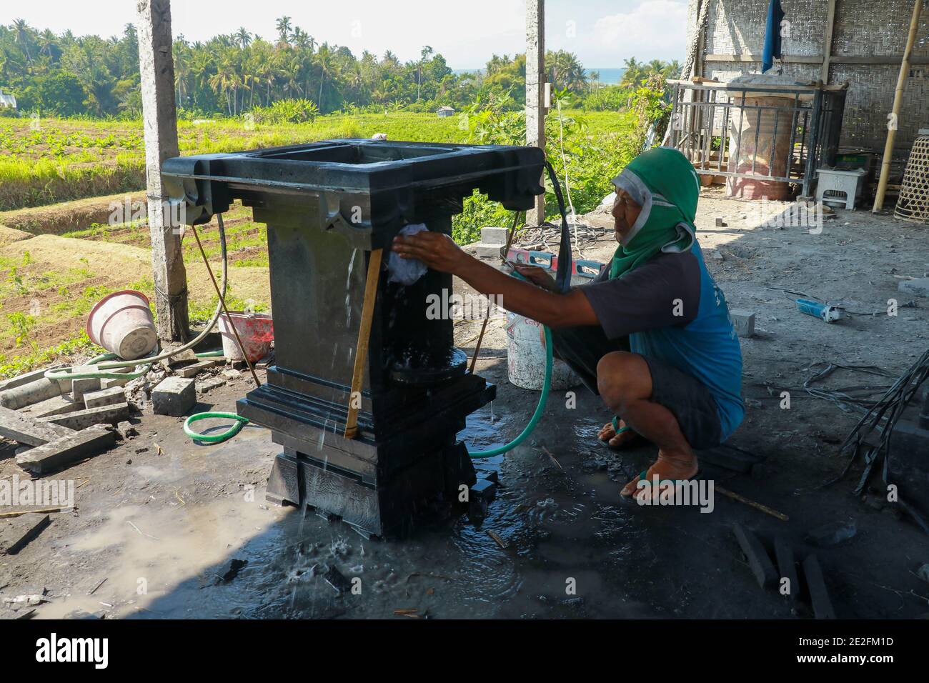 Asian man is washing the stone slabs in factory. cutted stone slabs on ...
