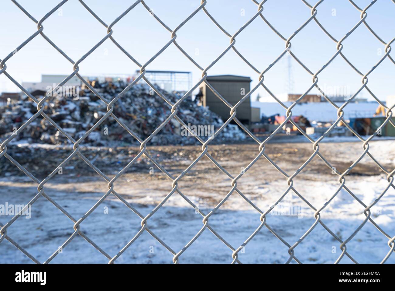Chain link fence with Garbage recycle dump behind it Stock Photo - Alamy