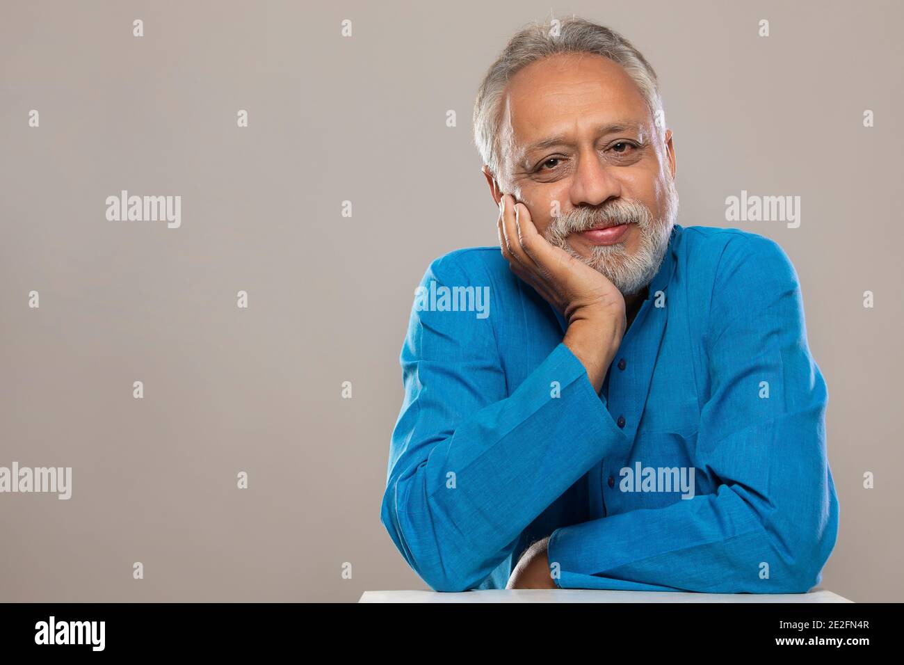 Old man sitting at table hi-res stock photography and images - Alamy