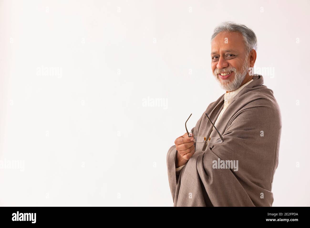 AN OLD MAN WITH SPECS IN HAND LOOKING AT CAMERA AND SMILING Stock Photo ...