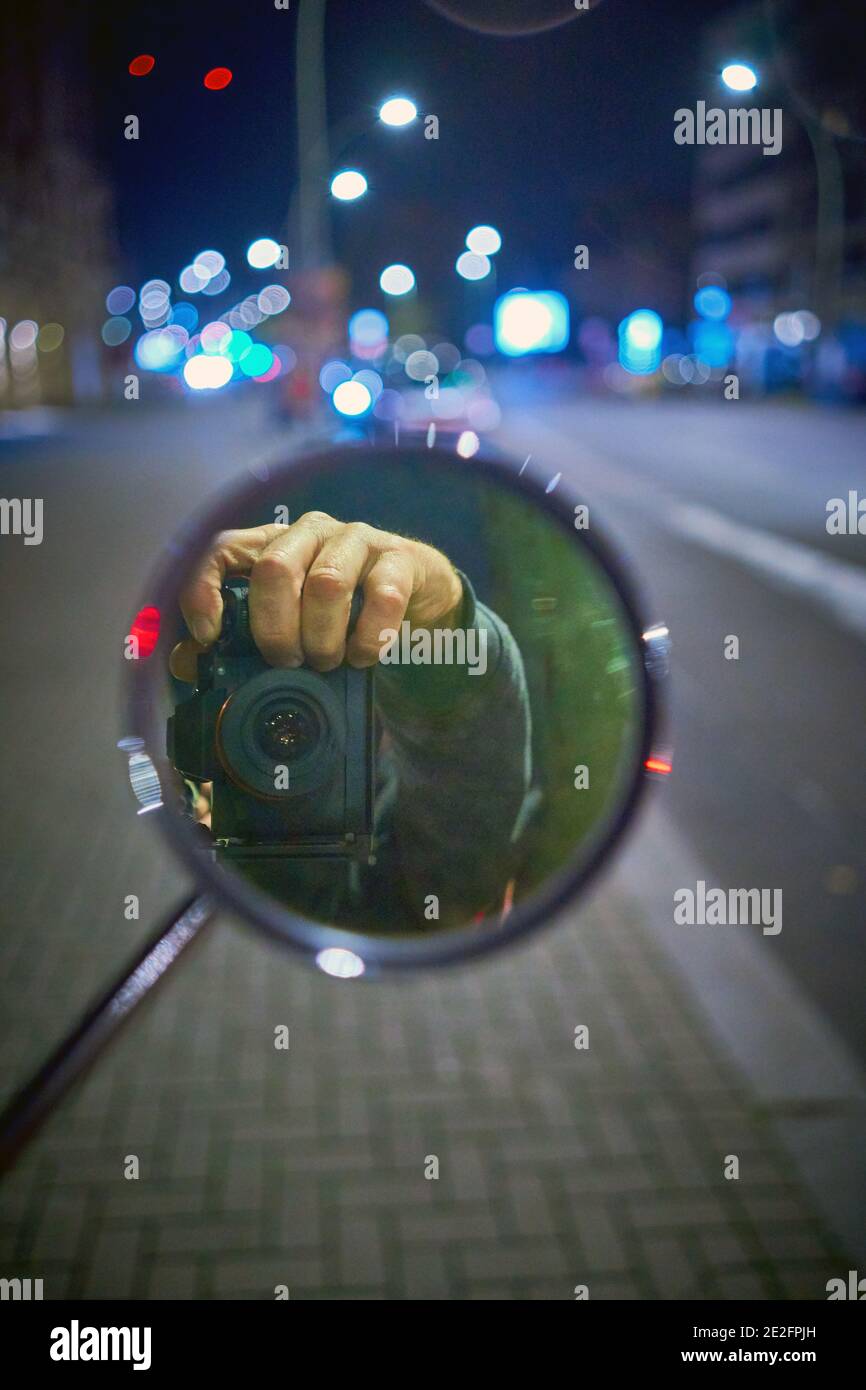 Vertical selective focus closeup of a mirror with the reflection of a ...