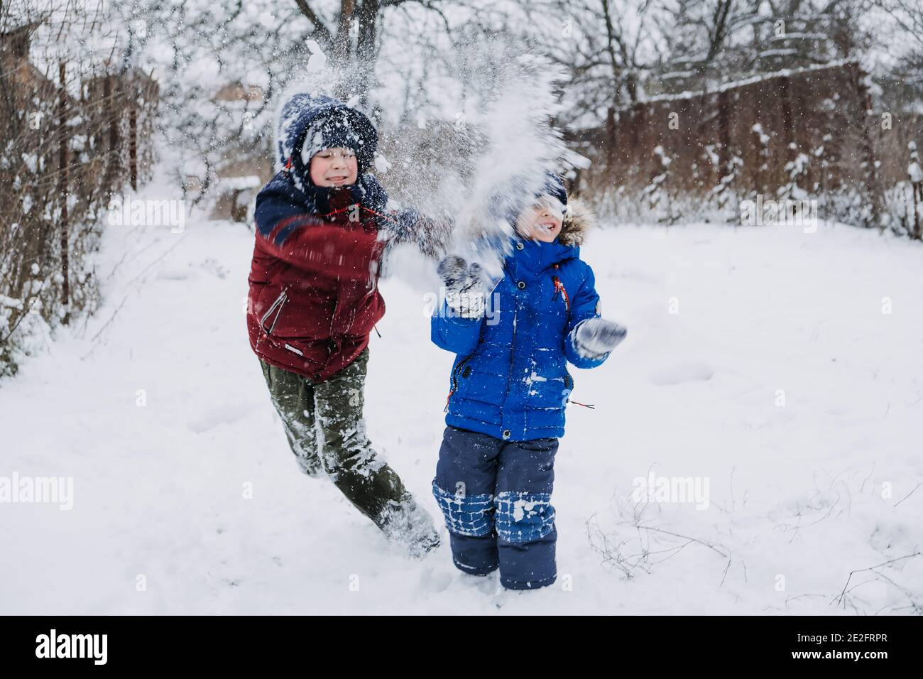 Outdoor winter activities for kids. Kids playing in the suburbs, winter ...