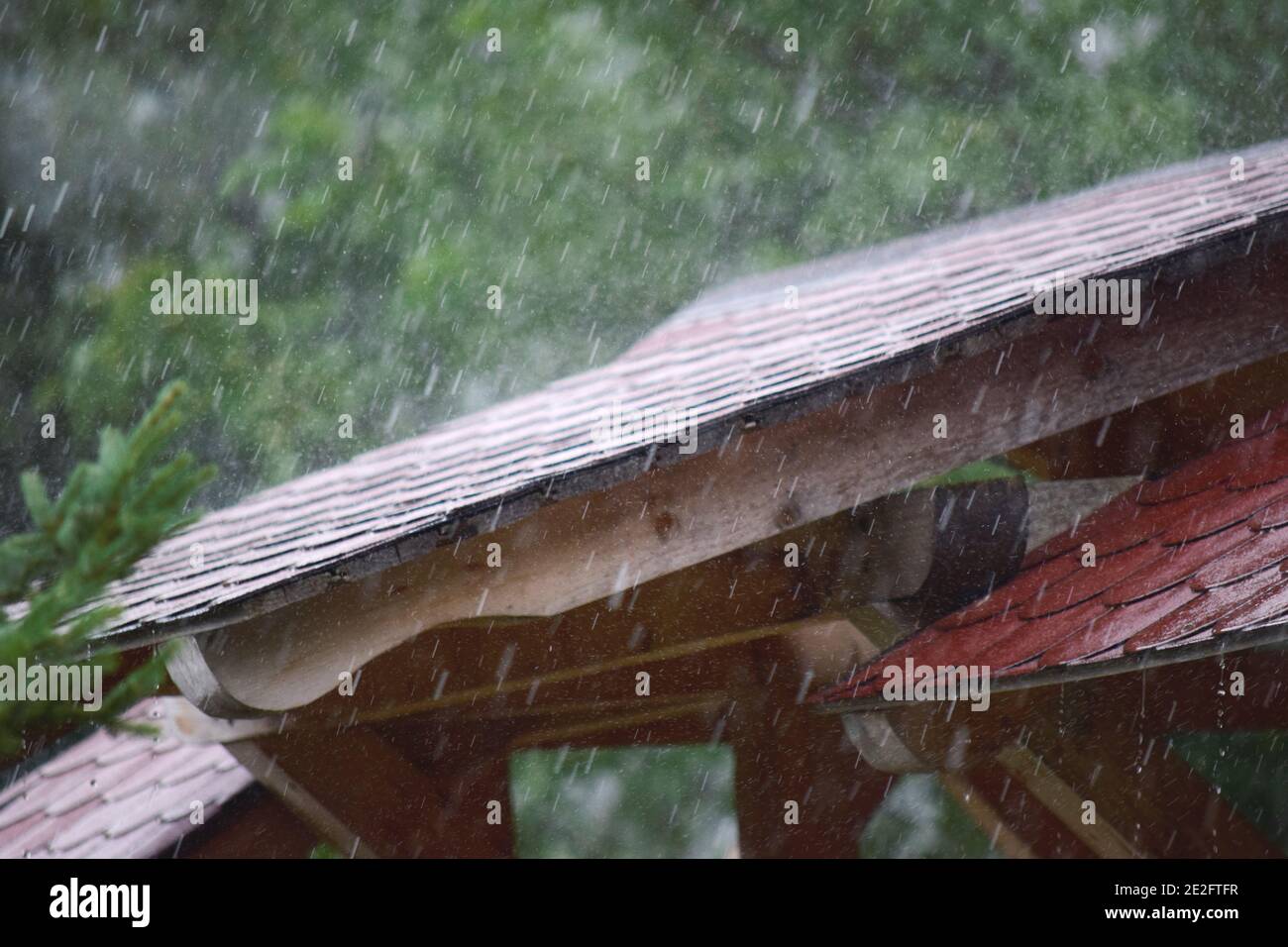 Closeup of heavy rainfall on red roofs surface Stock Photo - Alamy