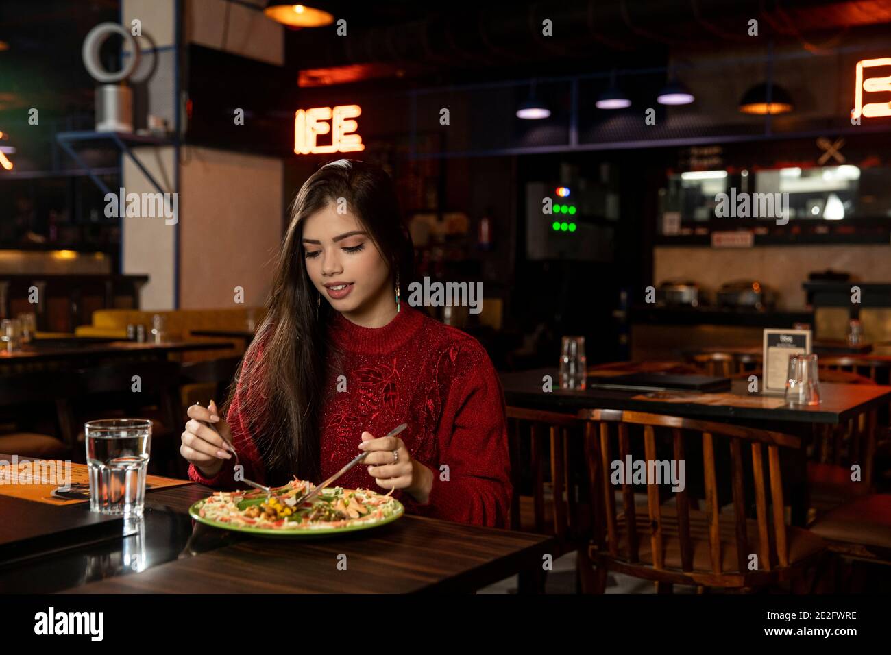 Portrait of a young pretty girl having lunch at the restaurant Stock ...