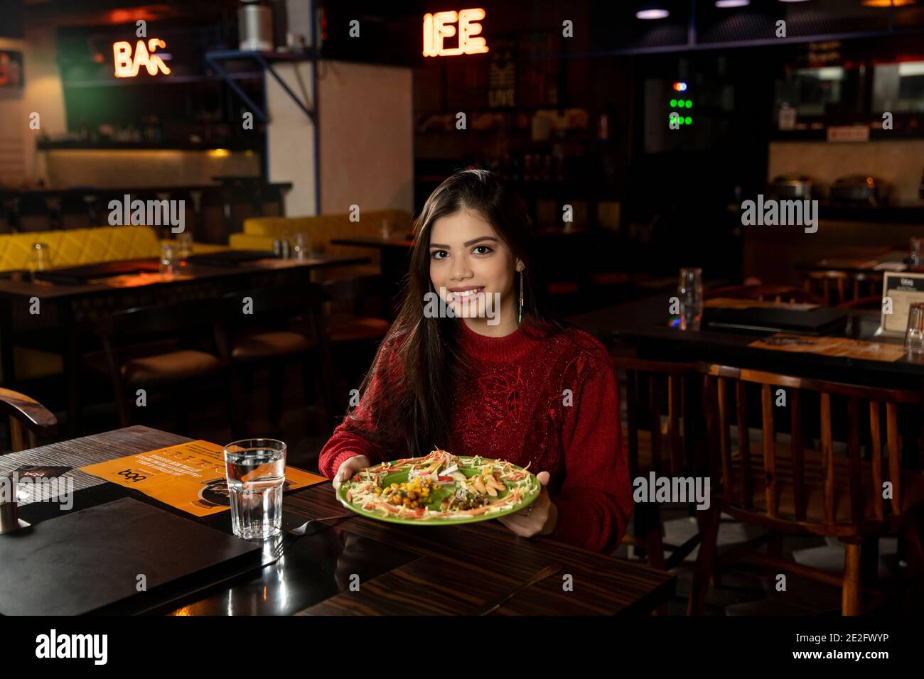 Portrait of a young pretty girl having lunch at the restaurant Stock ...