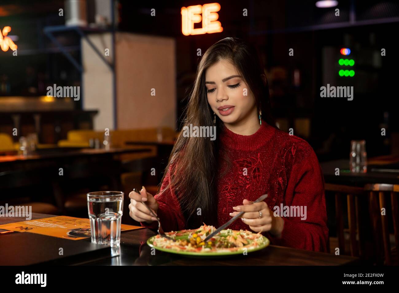 Portrait of a young pretty girl having lunch at the restaurant Stock ...