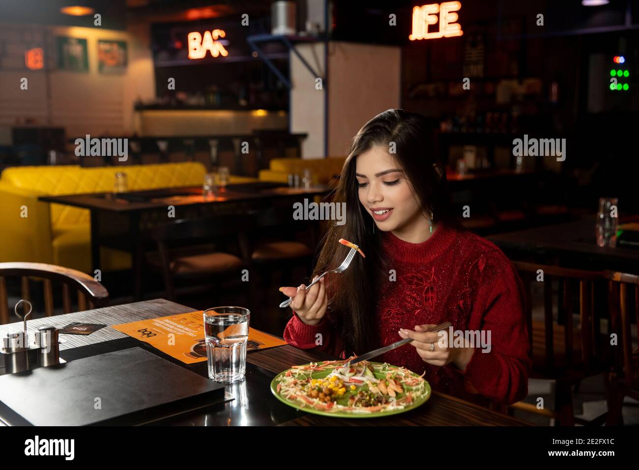 Portrait of a young pretty girl having lunch at the restaurant Stock ...