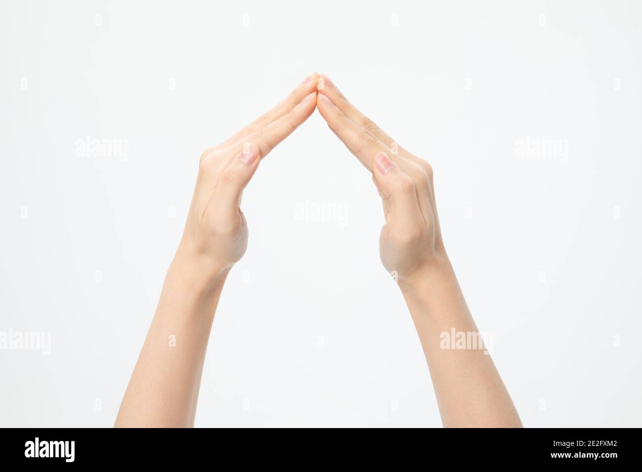 Closeup shot of hands forming a triangle isolated on a white background ...