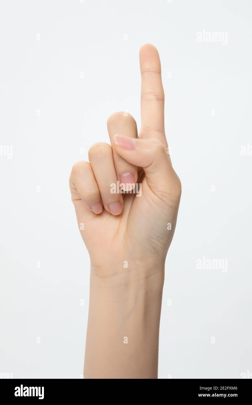 Vertical shot of a hand gesturing one isolated on a white background ...