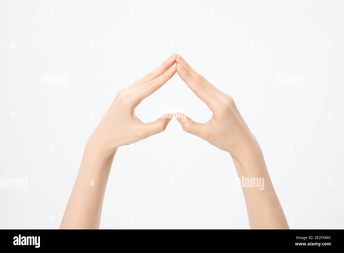 Closeup shot of hands showing a heart upside down isolated on a white ...