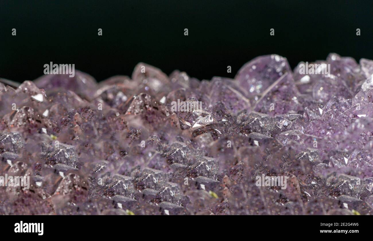 Selective shot of a quartz rock with inclusions on the black background ...