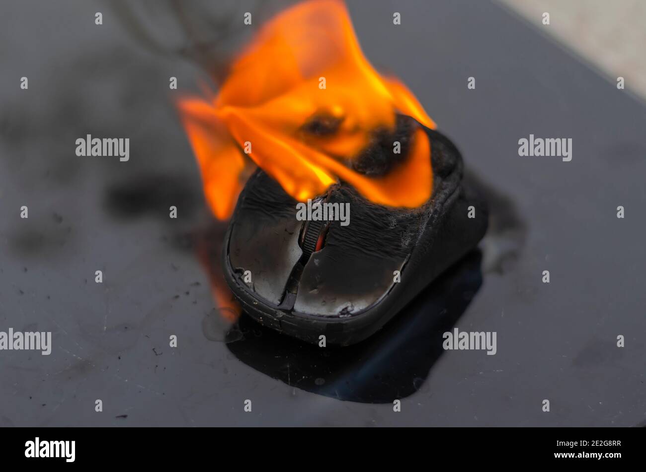 Household electrical appliance fire concept. Wireless computer mouse is ...