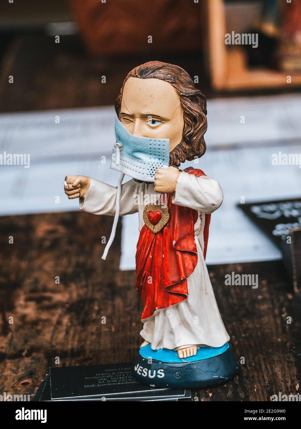 Vertical closeup of Jesus Christ figure wearing a mask-concept COVID19 ...