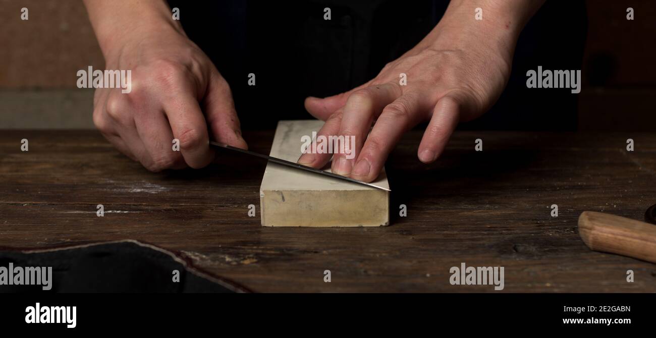 Knife sharpening with sharpening stone/block Stock Photo - Alamy