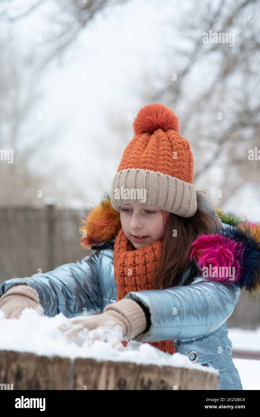 Winter portrait of young girl in her warm clothing. Teenage girl in a ...