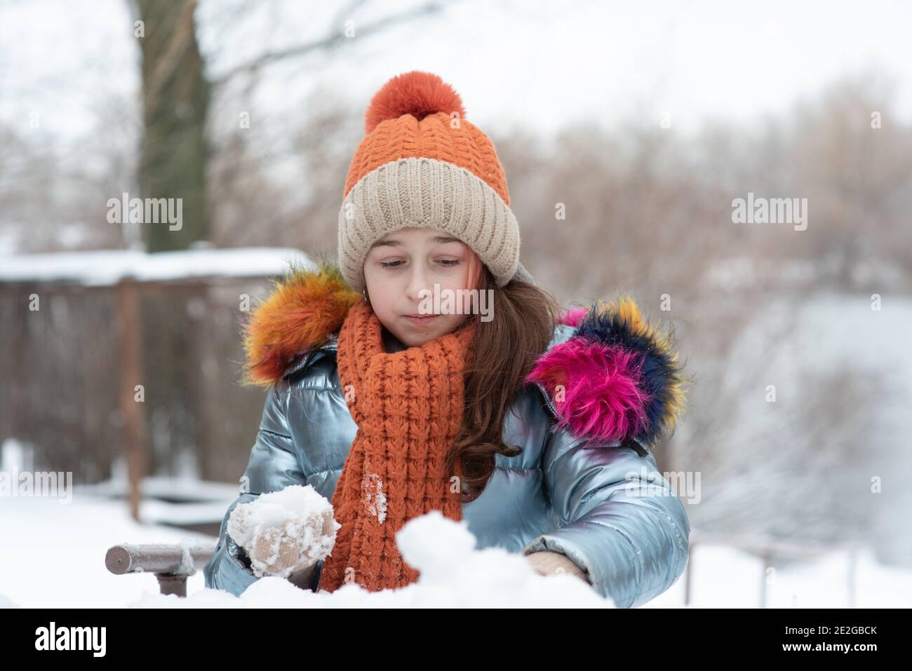 Winter portrait of young girl in her warm clothing. Teenage girl in a ...