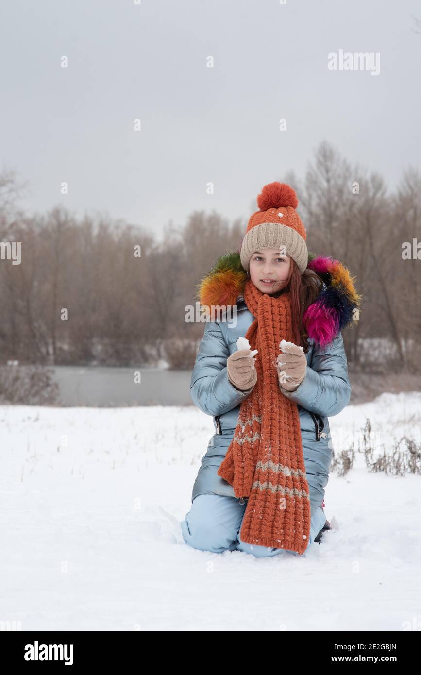 Winter portrait of young girl in her warm clothing. Teenage girl in a ...