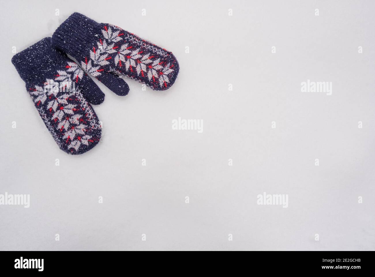 Christmas New Year winter background with warm mittens in the snow ...