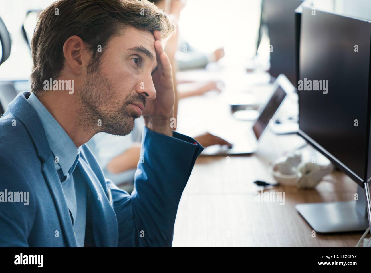 Young tired, ill, overworked business man in formal wear sitting in ...
