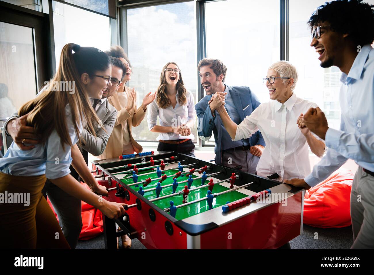 Colleagues playing table football in the break Stock Photo - Alamy