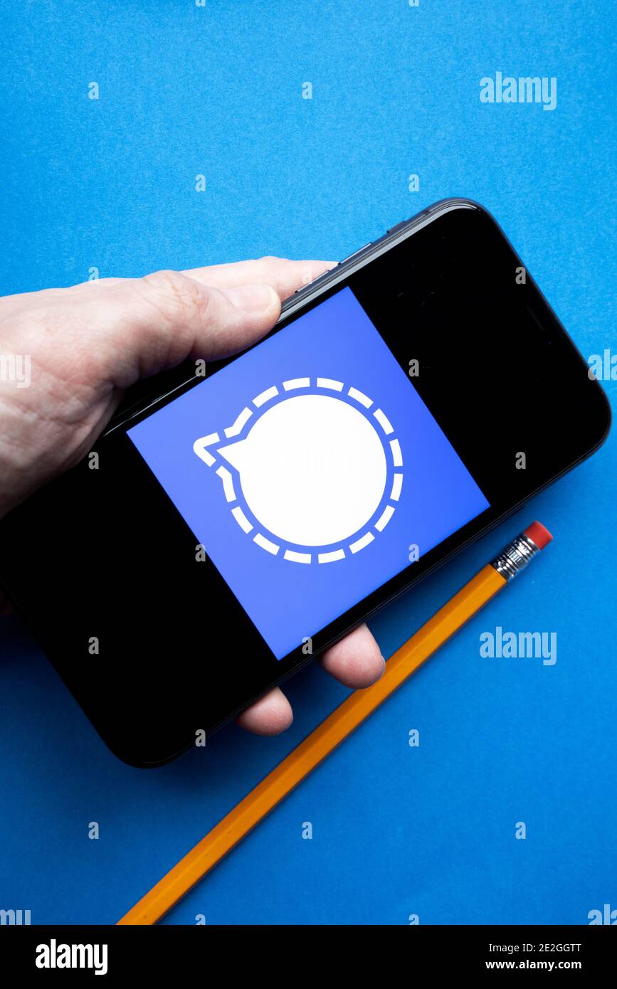 iPhone 11 on blue background with new messenger app Signal logo and ...