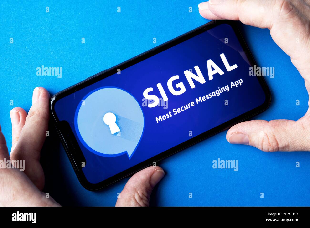 iPhone 11 on blue background with new messenger app Signal logo and ...