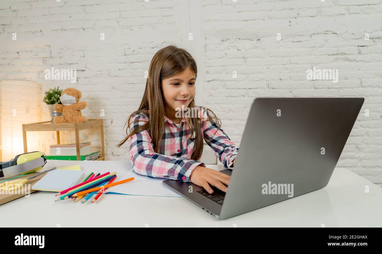 Happy Schoolgirl on laptop studying online in a virtual remote class on ...
