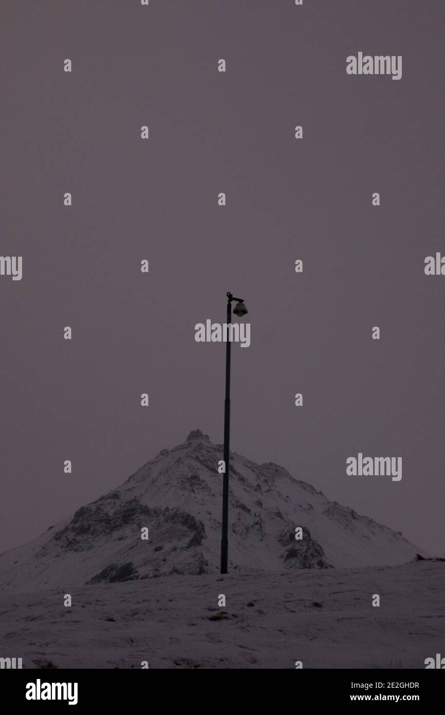 Street lamp against snowy mountain, Arnastapi, Iceland Stock Photo - Alamy