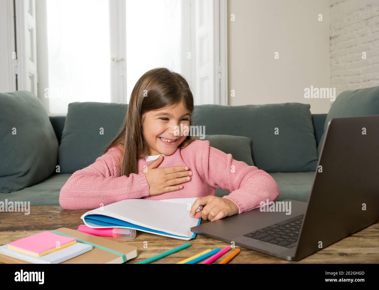 Happy Schoolgirl on laptop studying online in a virtual remote class on ...