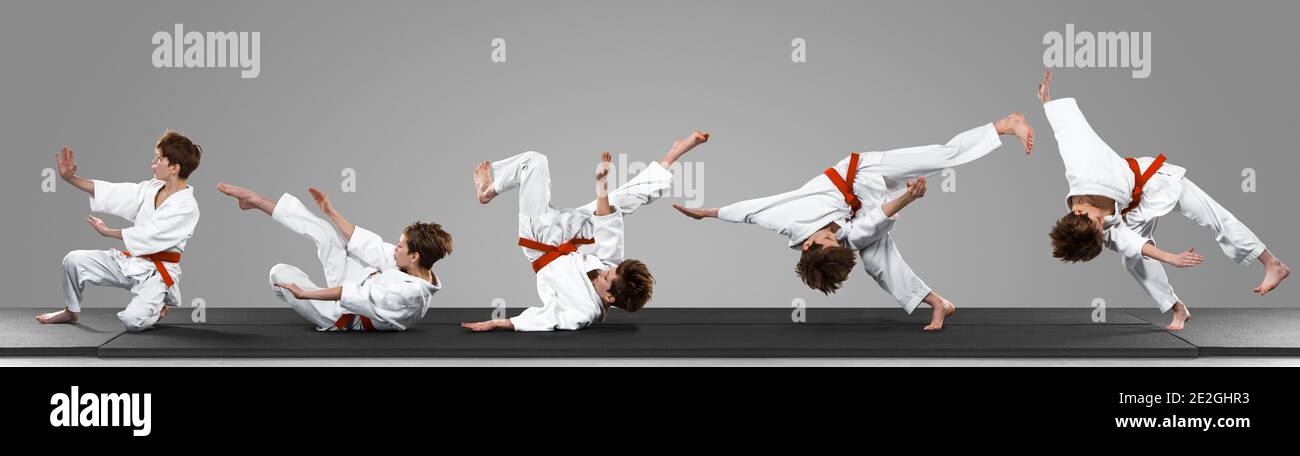 Young judo caucasian male fighter in white kimono with red belt in ...