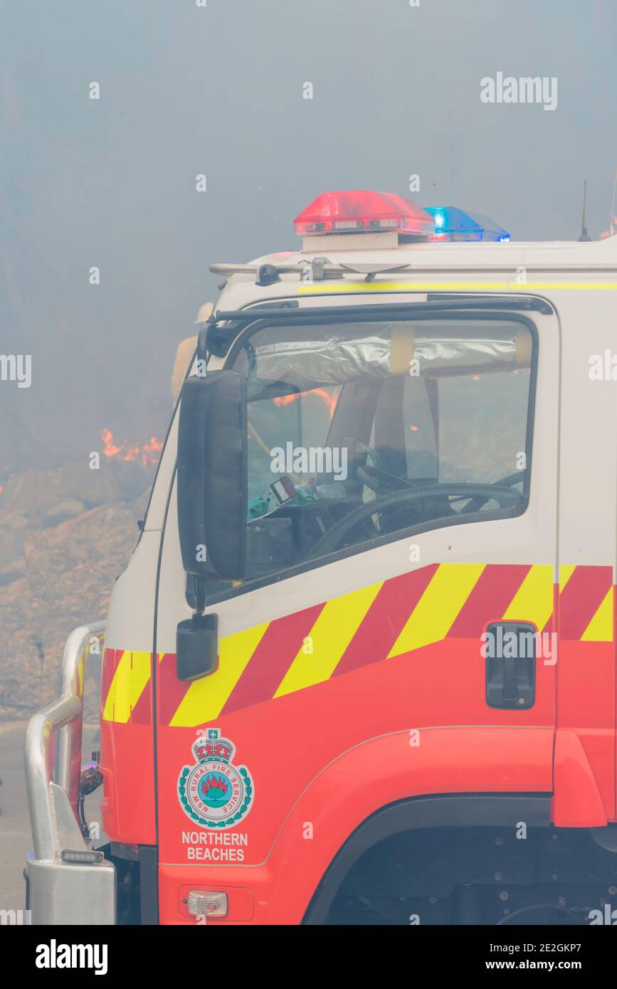 The front of a Rural Fire Service truck with lights flashing, in thick ...