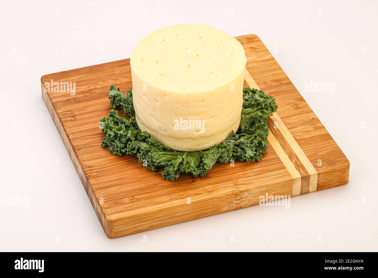 Yellow round dairy soft cheese piece Stock Photo - Alamy