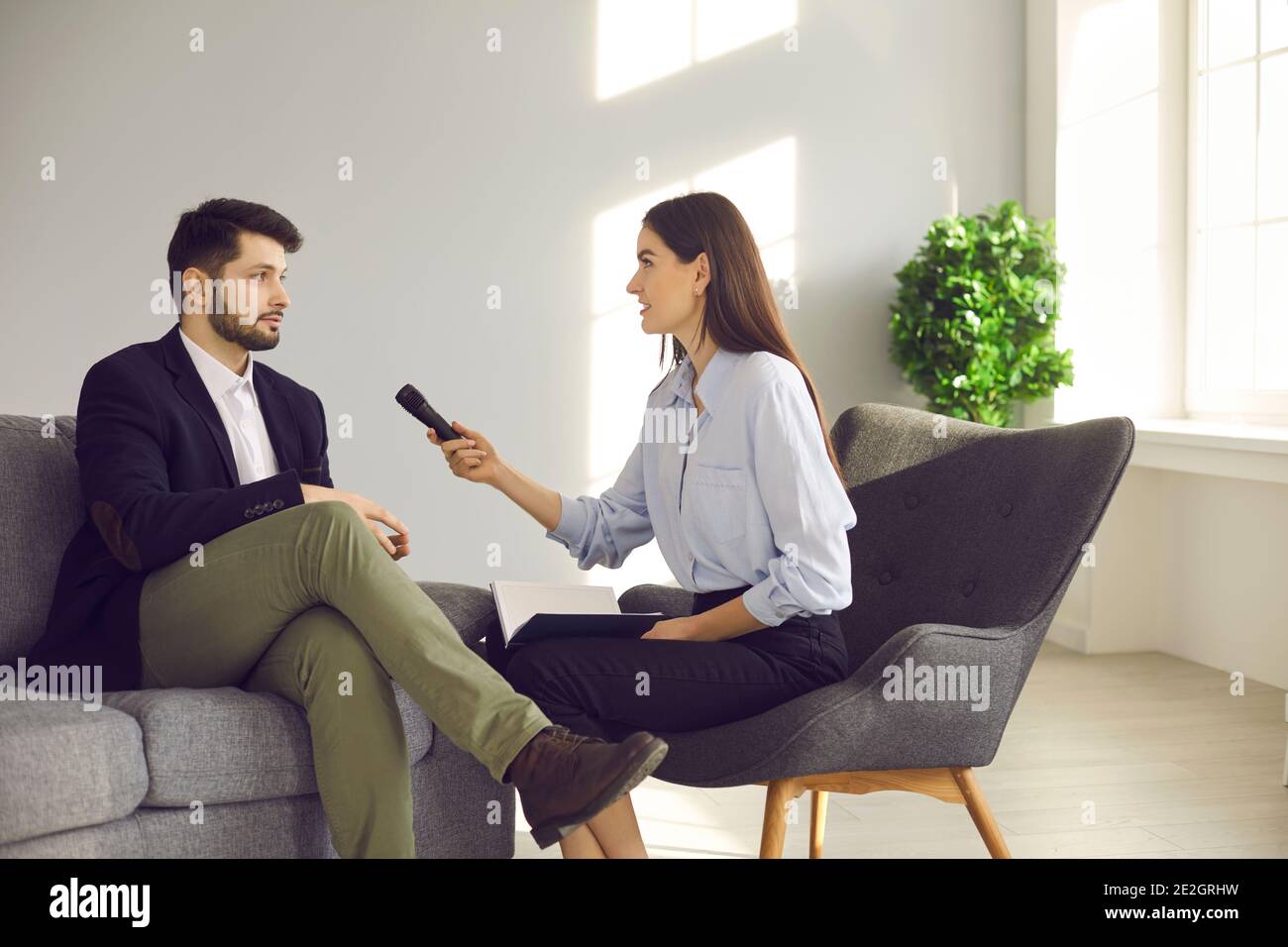 Newspaper journalist or TV host doing interview with celebrity or ...
