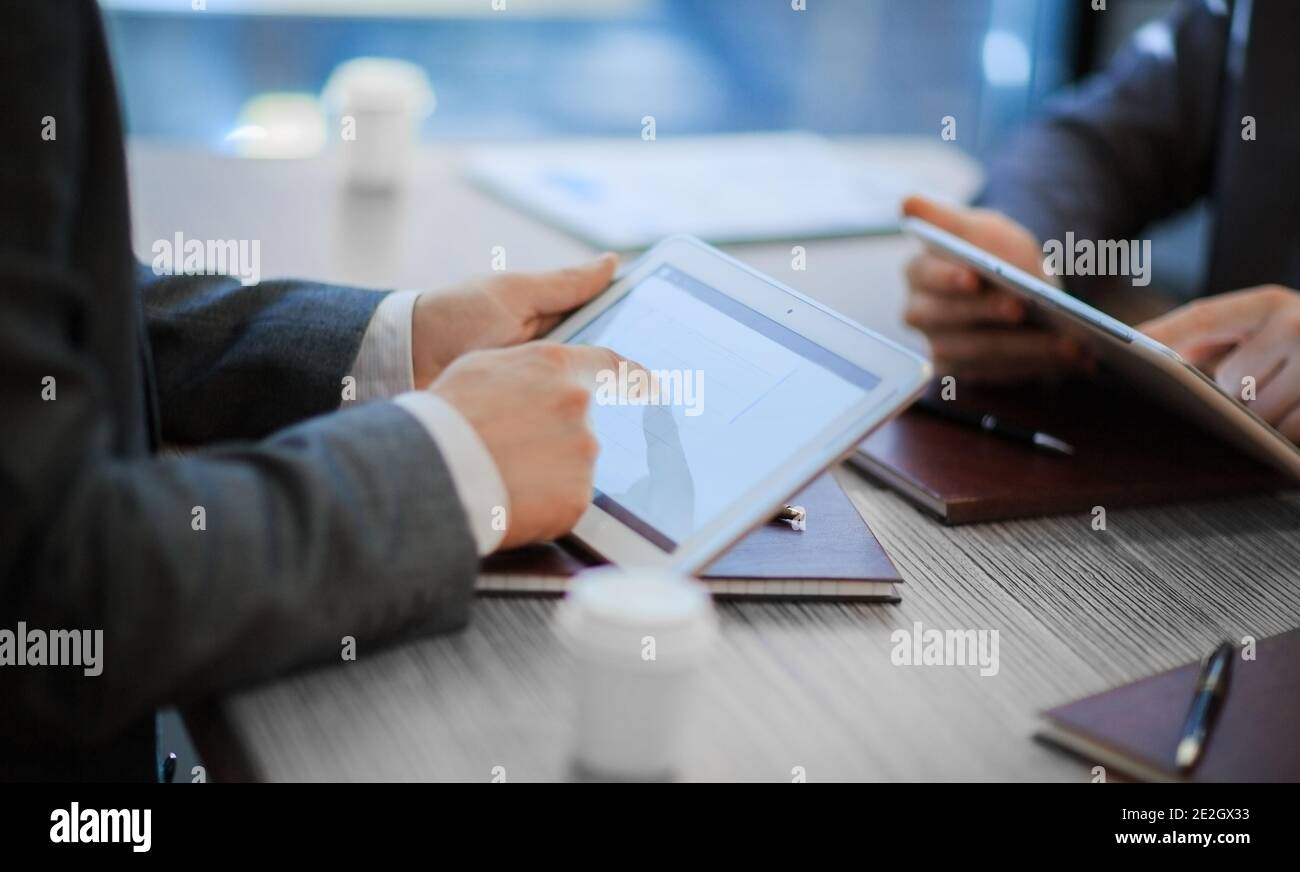 business partners with digital tablets discussing a new contract Stock ...