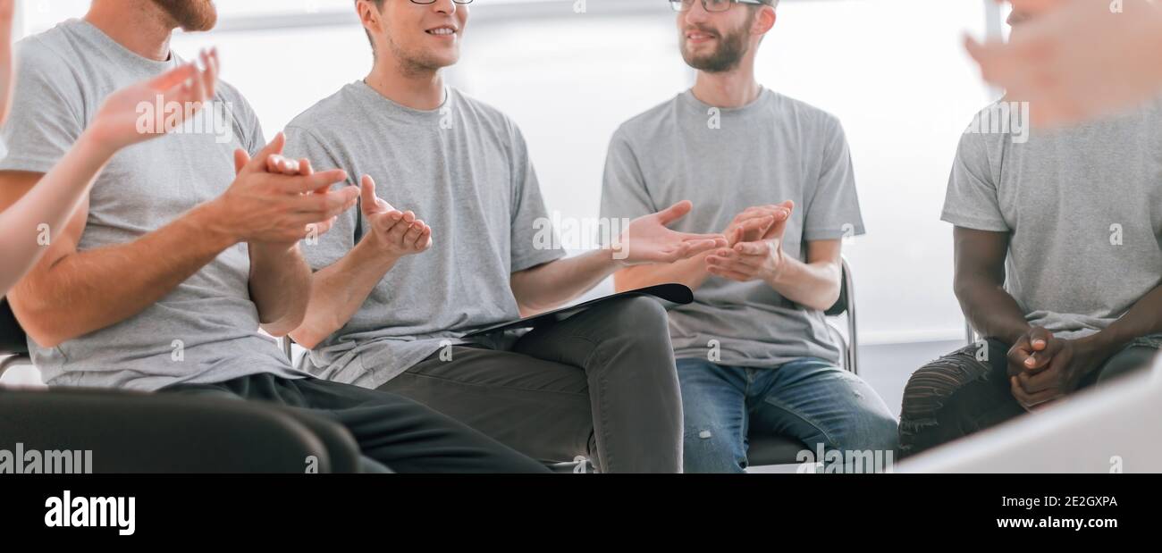 young man explaining something to his associates Stock Photo - Alamy