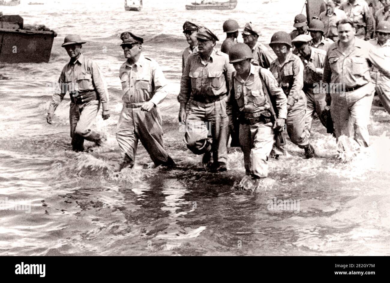 General Douglas MacArthur (second from left) walks to the shore of ...