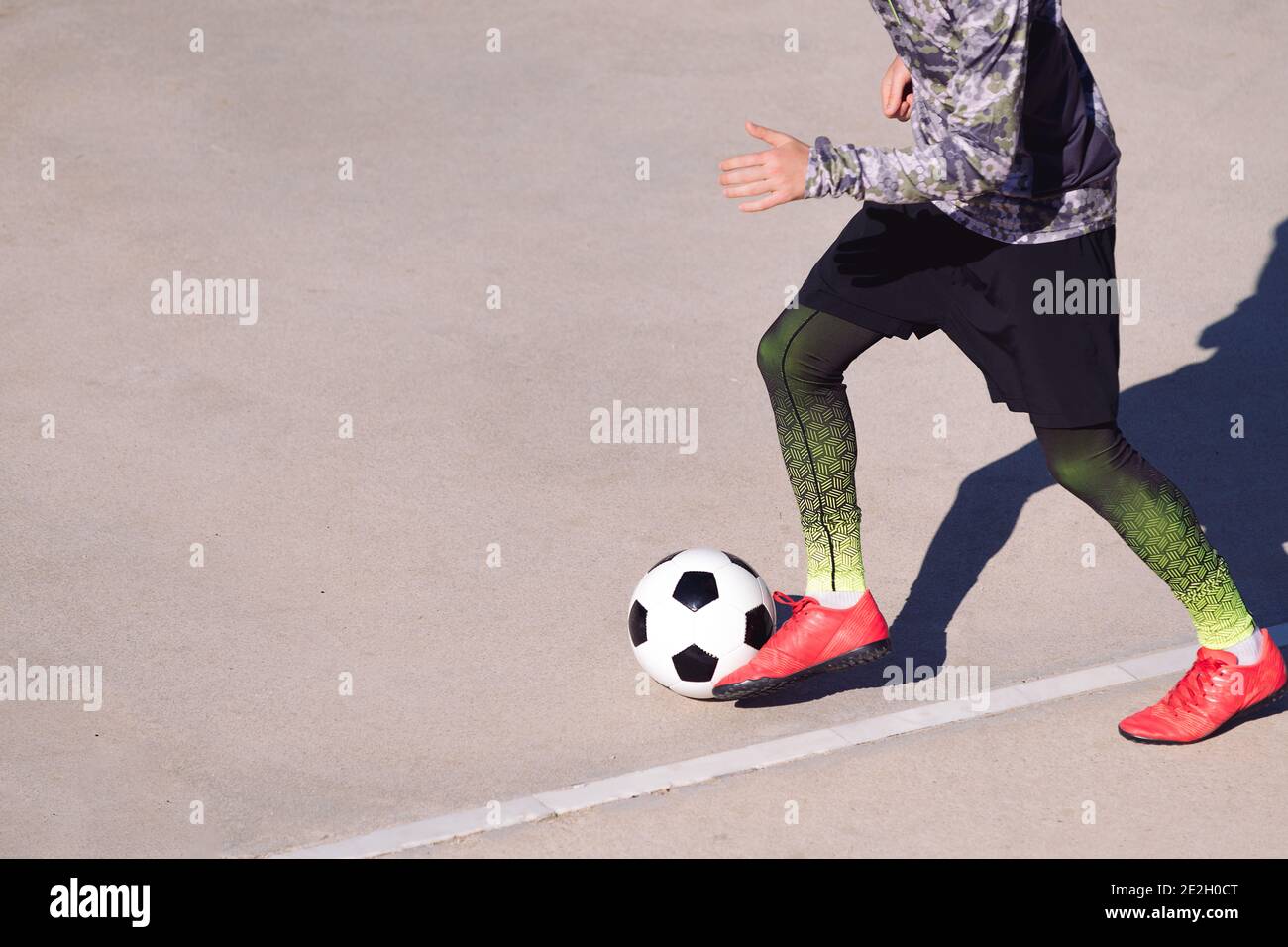 legs of an unrecognizable football player running with the ball in a ...