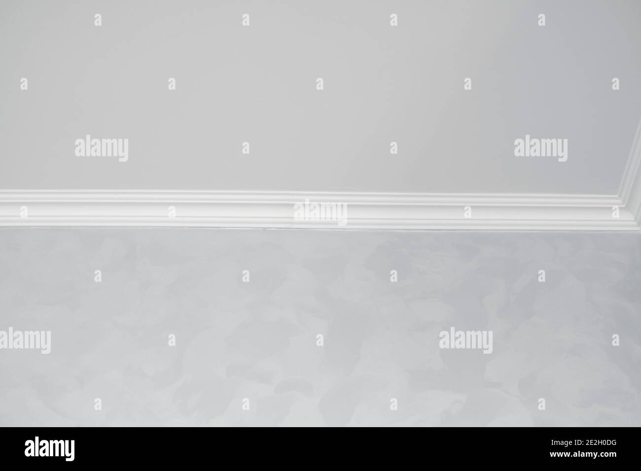 White ceiling with a white plinth in a room with gray painted walls ...