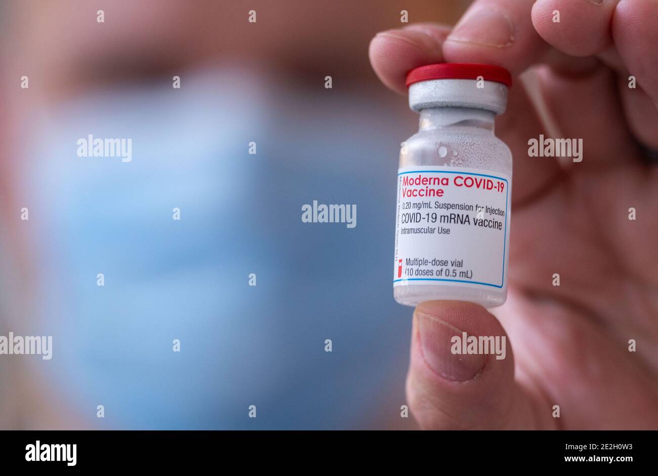 Stuttgart, Germany. 14th Jan, 2021. A man holds a vial of a Covid-19 ...