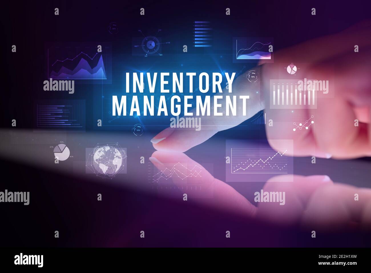 Finger touching tablet with charts and INVENTORY MANAGEMENT inscription ...
