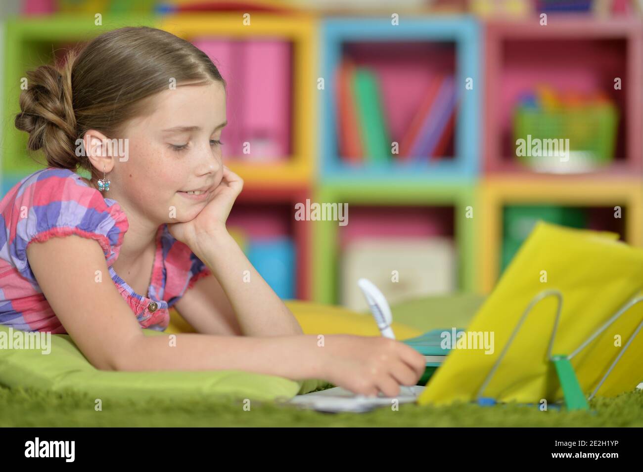 Little cute girl doing homework at home Stock Photo - Alamy